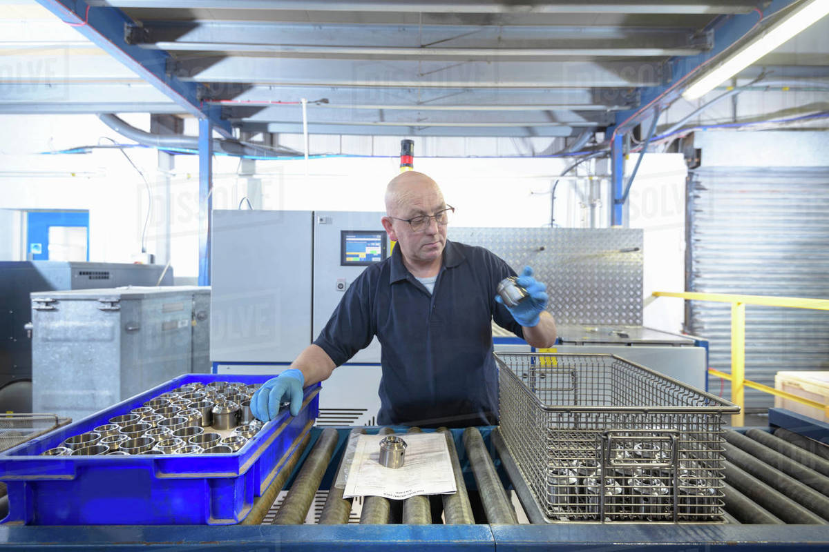 Worker degreasing components in electroplating factory - Stock Photo ...