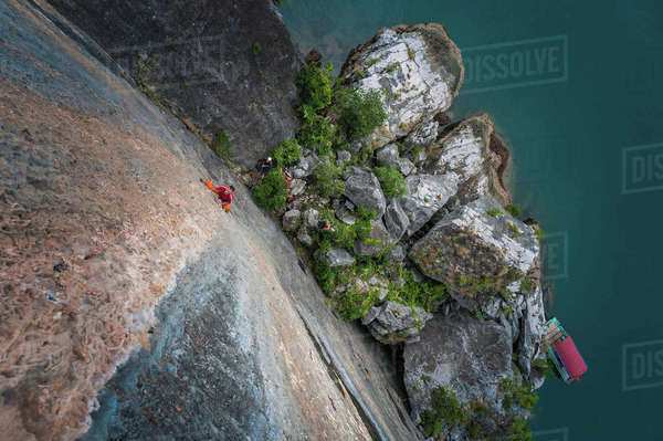 Man rock climbing on limestone rock, overhead view, Ha Long Bay ...