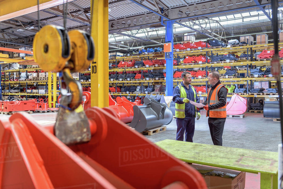 Workers in discussion in dispatch department in engineering factory ...
