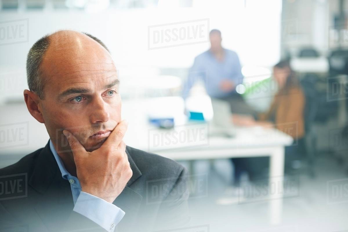 Man thinking, people in background - Stock Photo - Dissolve