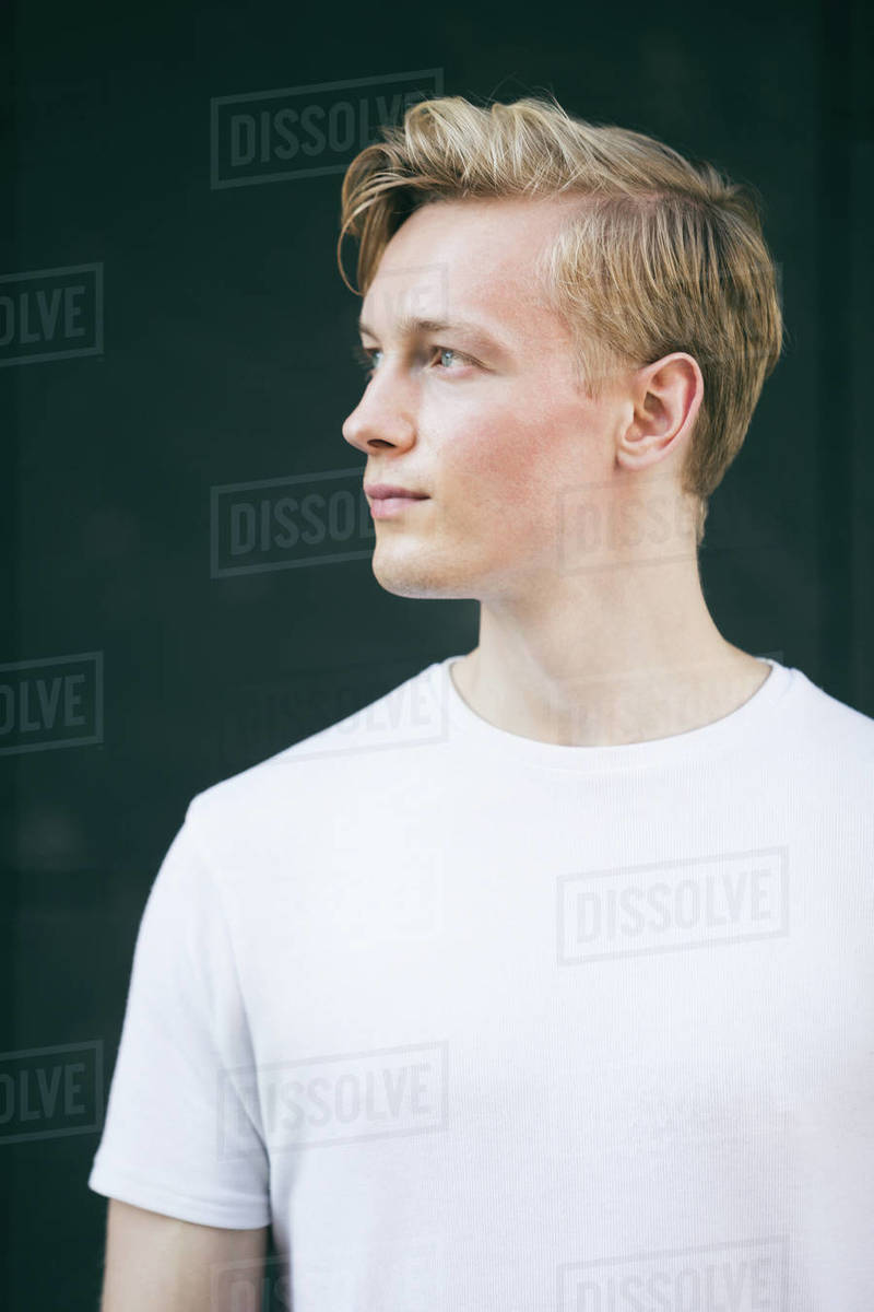 Young man, black background - Royalty-free Stock Photo | Dissolve