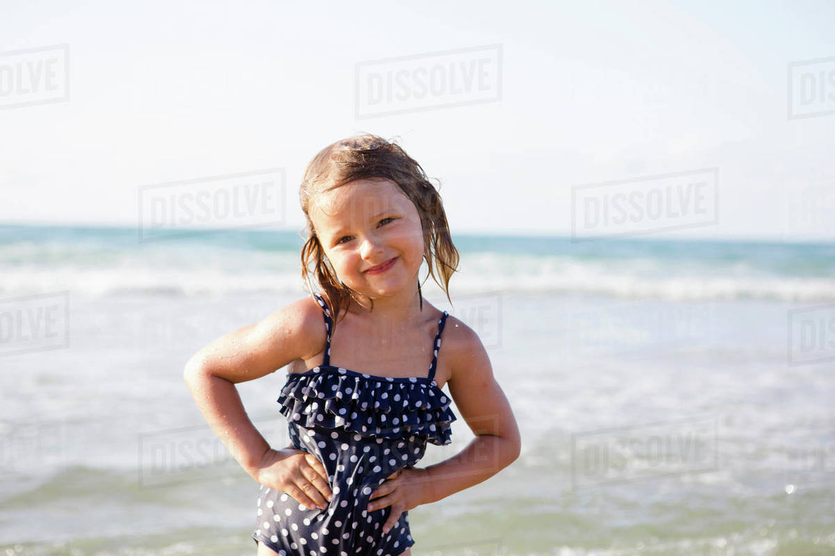 Cute girl on beach in spotted swimming costume, portrait, Castellammare ...