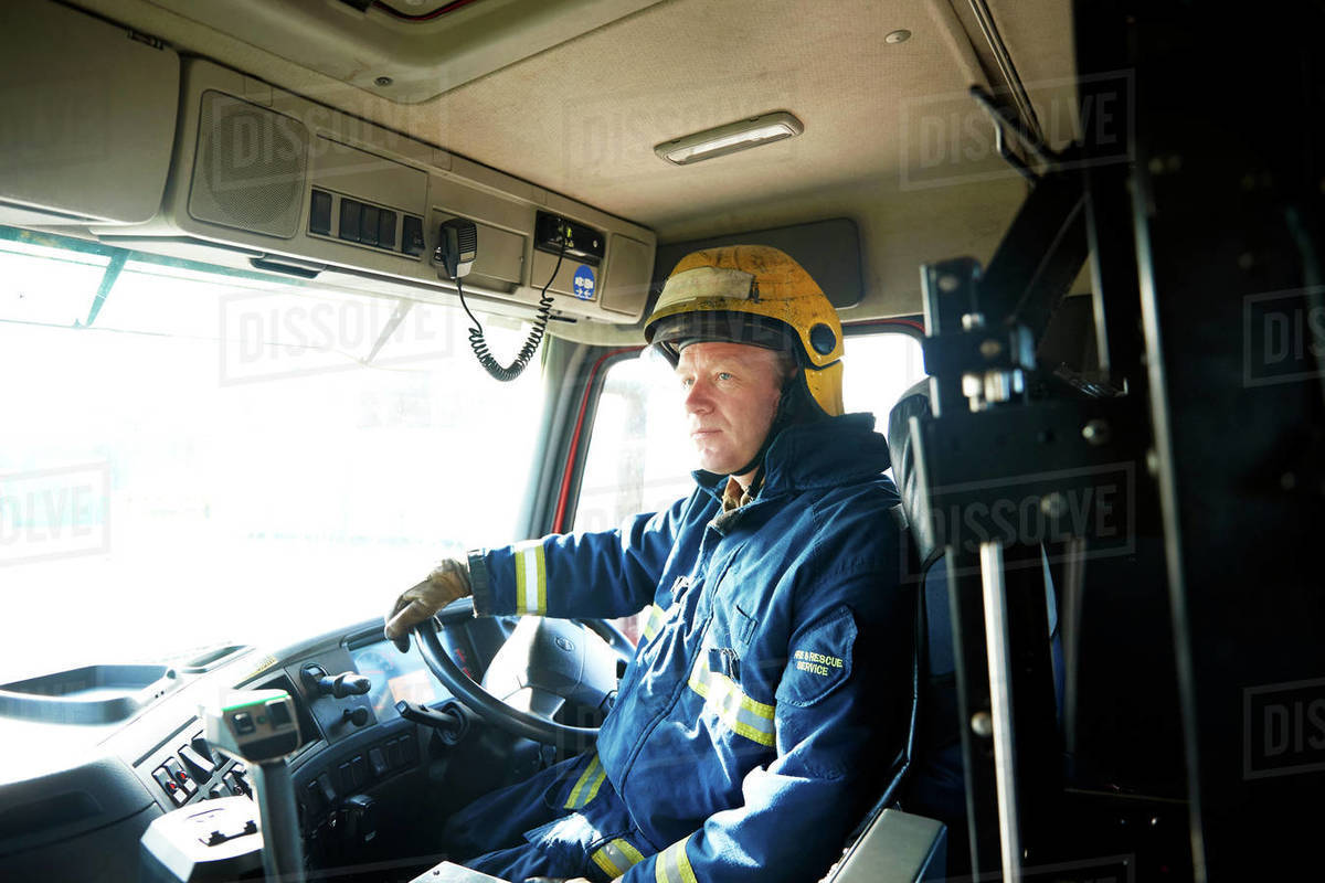 Fireman at wheel of fire engine - Royalty-free Stock Photo | Dissolve