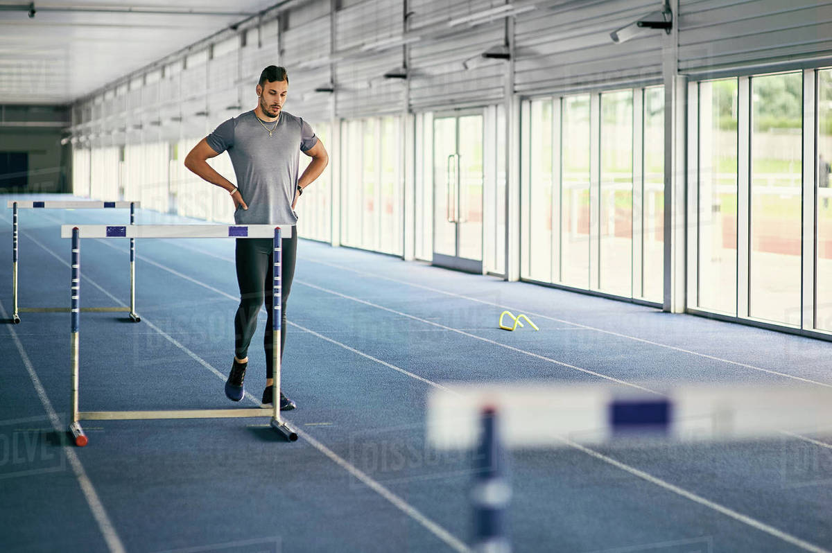 Runner training on indoor running track - Stock Photo - Dissolve