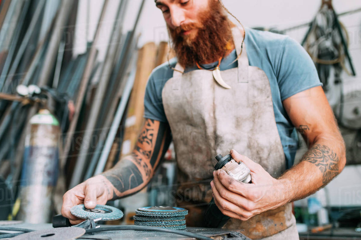 Axe maker using steel grinder in workshop - Royalty-free Stock Photo ...