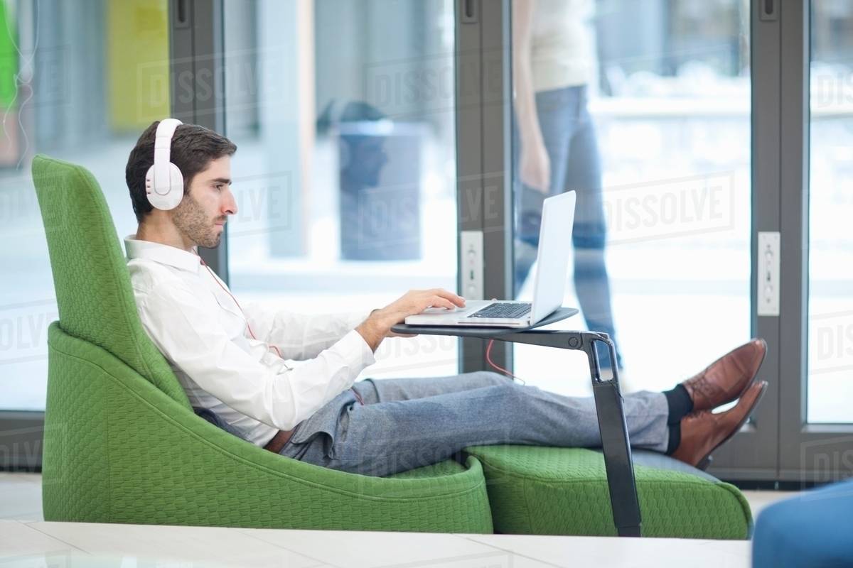 Male office worker using laptop - Royalty-free Stock Photo | Dissolve