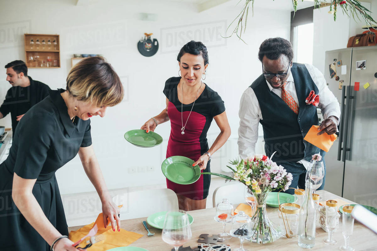 Businessmen and businesswomen celebrating at lunch party in loft office ...