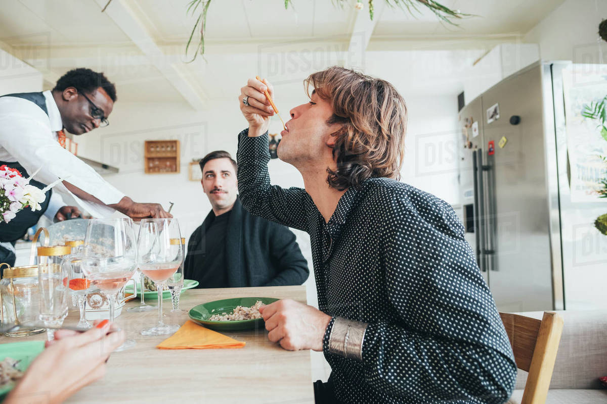 Businessmen and businesswomen celebrating at lunch party in loft office ...
