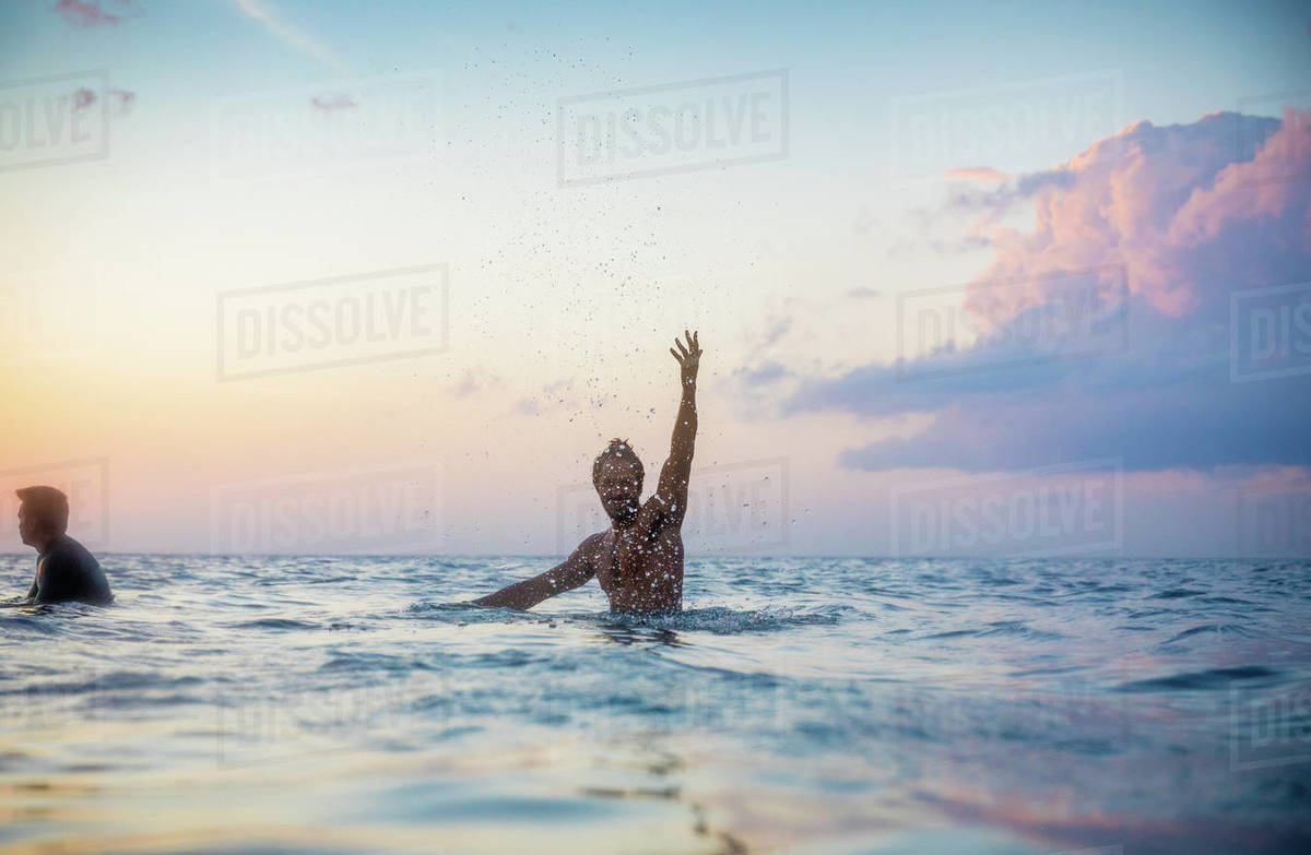 Man splashing in sea at sunset, Pagudpud, Ilocos Norte, Philippines ...