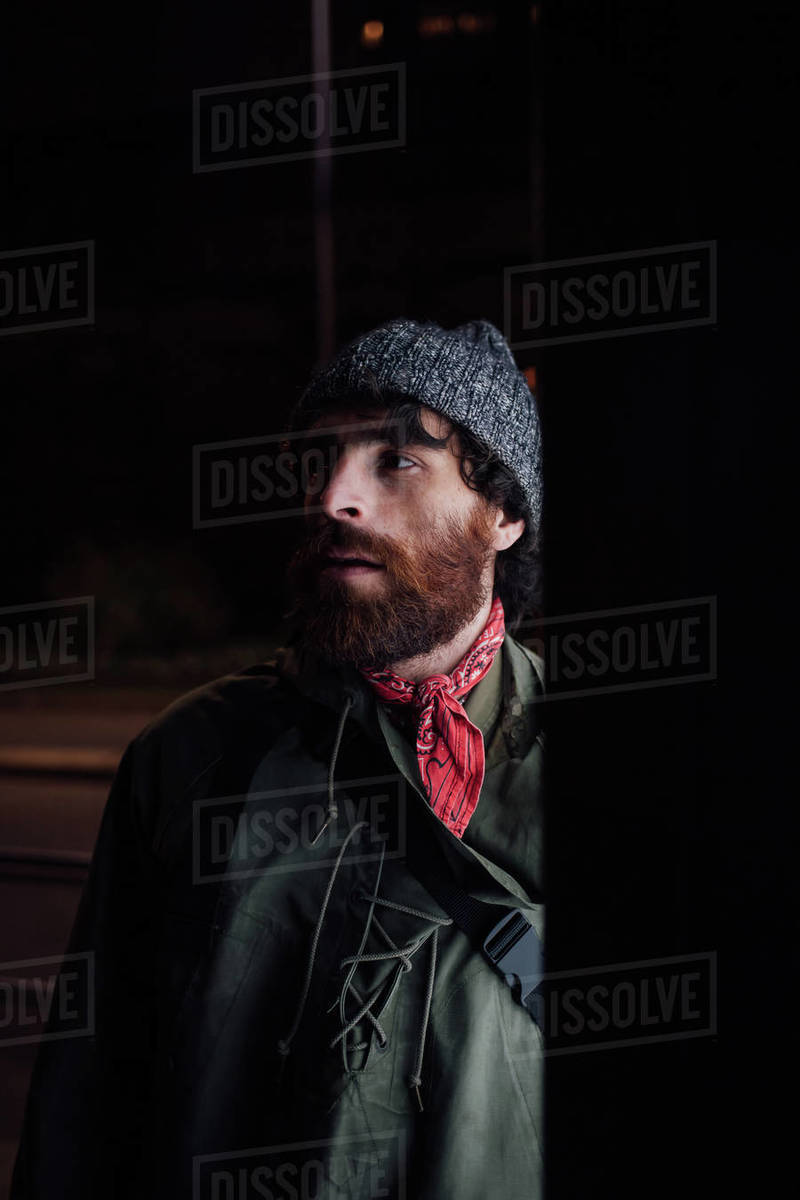 Bearded young man loitering on street - Royalty-free Stock Photo | Dissolve