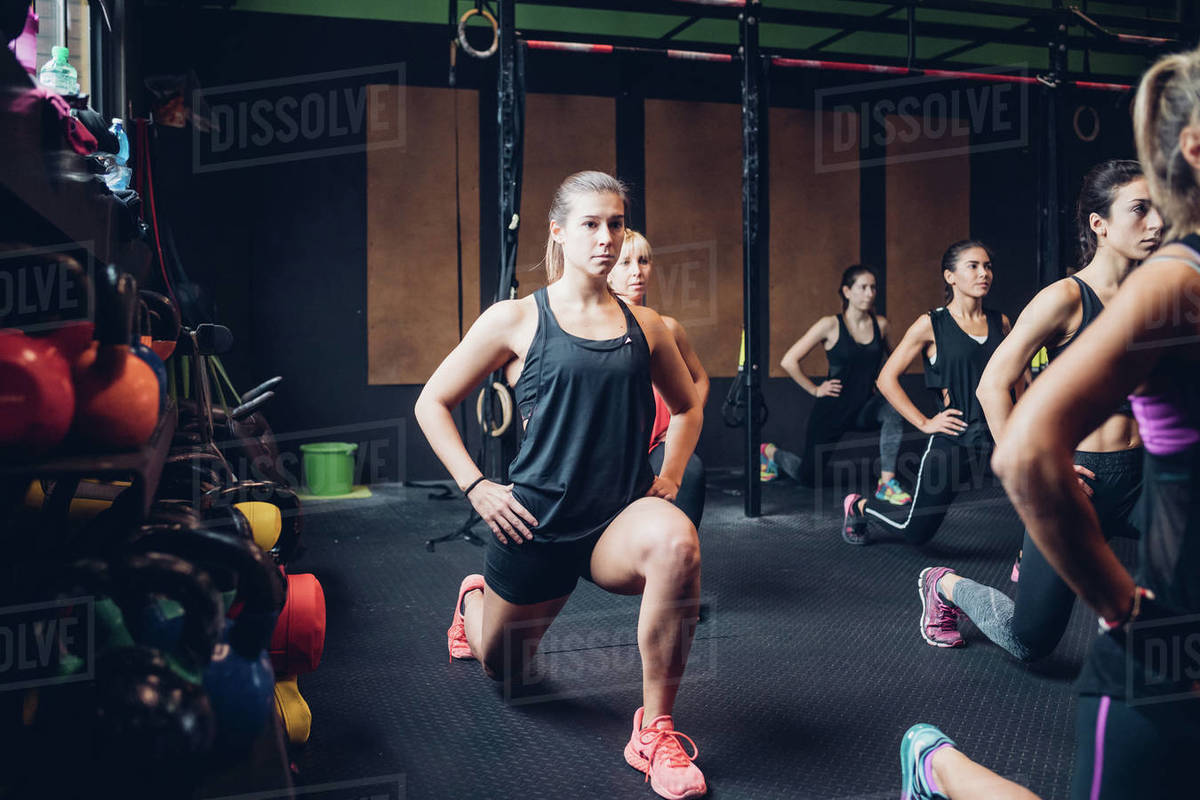 Group of women training in gym, stretching with hands on hips - Royalty ...