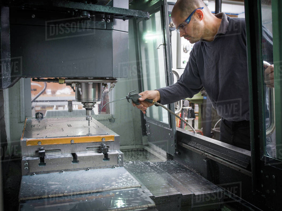 Knife factory worker operating cutting machinery - Royalty-free Stock ...