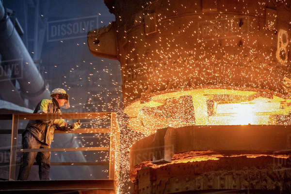 Steelworker starting molten steel pour in steelworks - Stock Photo ...