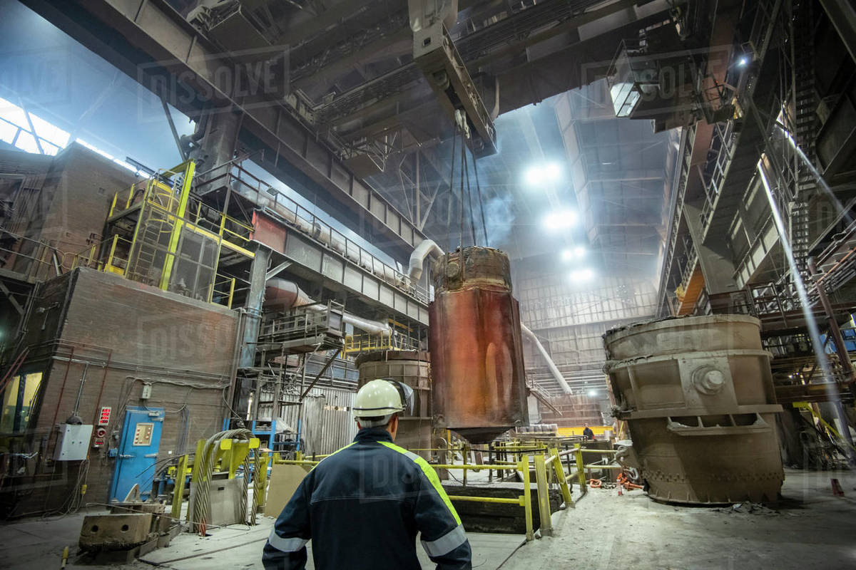 200 ton red hot steel ingot being lifted from mould in steelworks ...