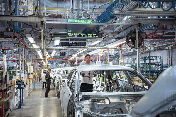 Workers on car production line in car factory - Stock Photo - Dissolve