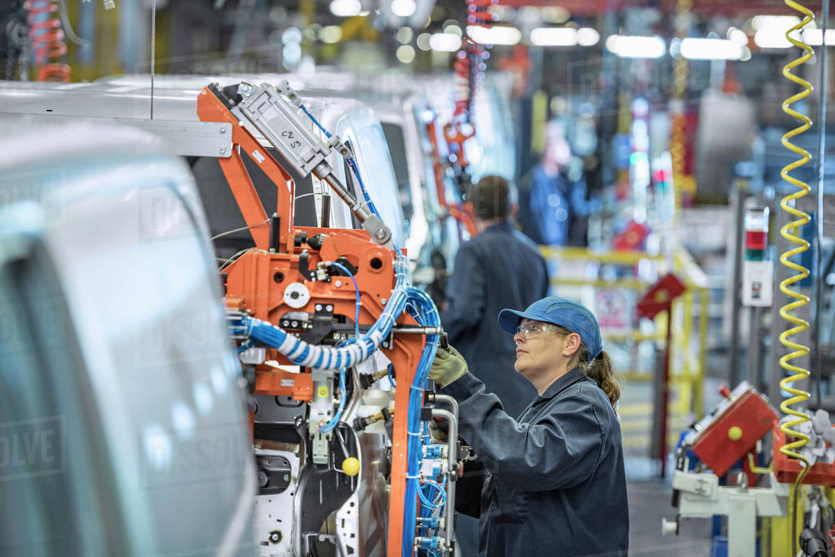 Female worker on vehicle production line in car factory - Stock Photo ...