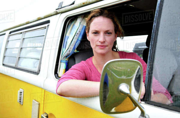 Mid adult woman looking out from camper van window, portrait - Stock ...