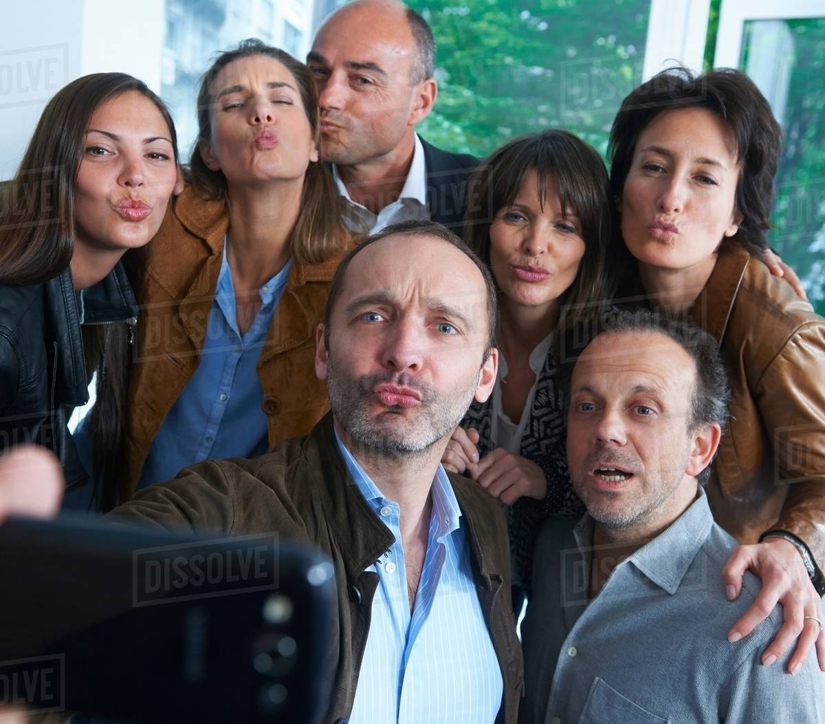 Group of people taking self portrait photograph - Stock Photo - Dissolve