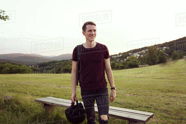 Man standing by bench, hills in background, Wilhelminenberg, Vienna ...