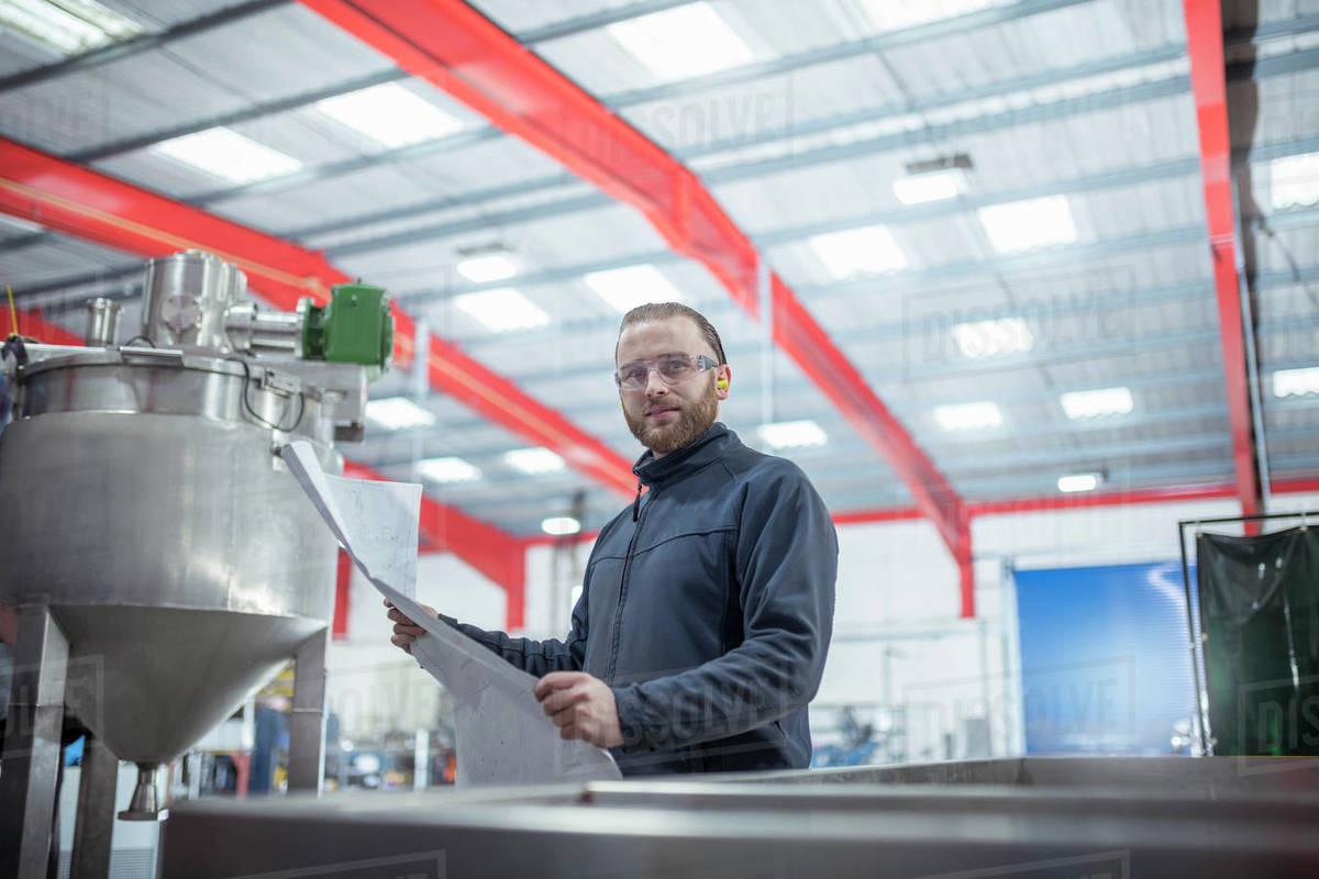 Portrait of engineer in metal fabrication factory. - Stock Photo - Dissolve
