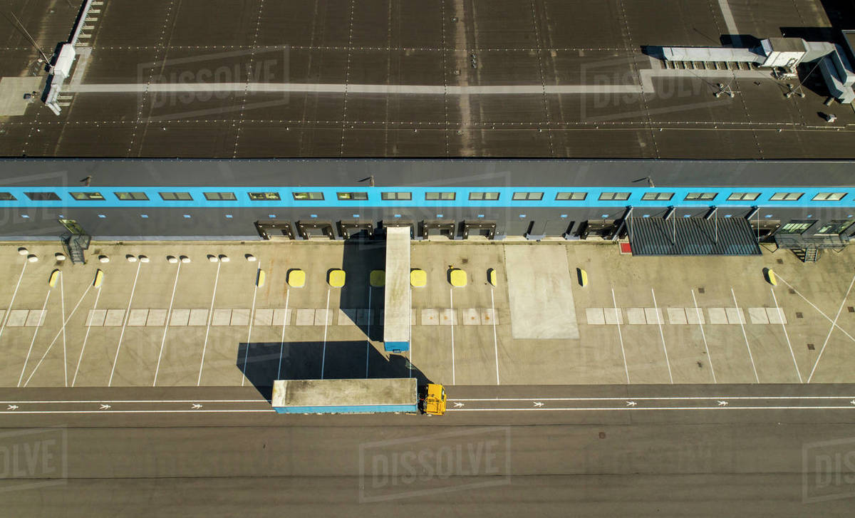 Birds eye view of lorries at a loading bay of an industrial unit ...