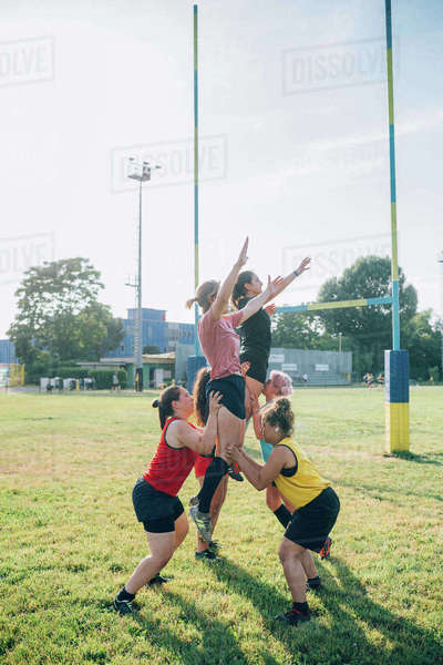 A group of women training for lineouts, four lifting and two being ...