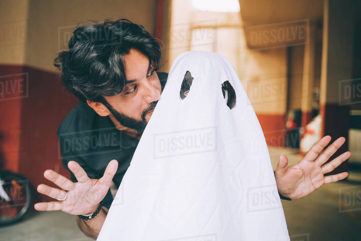 Father with child dressed as ghost - Stock Photo - Dissolve