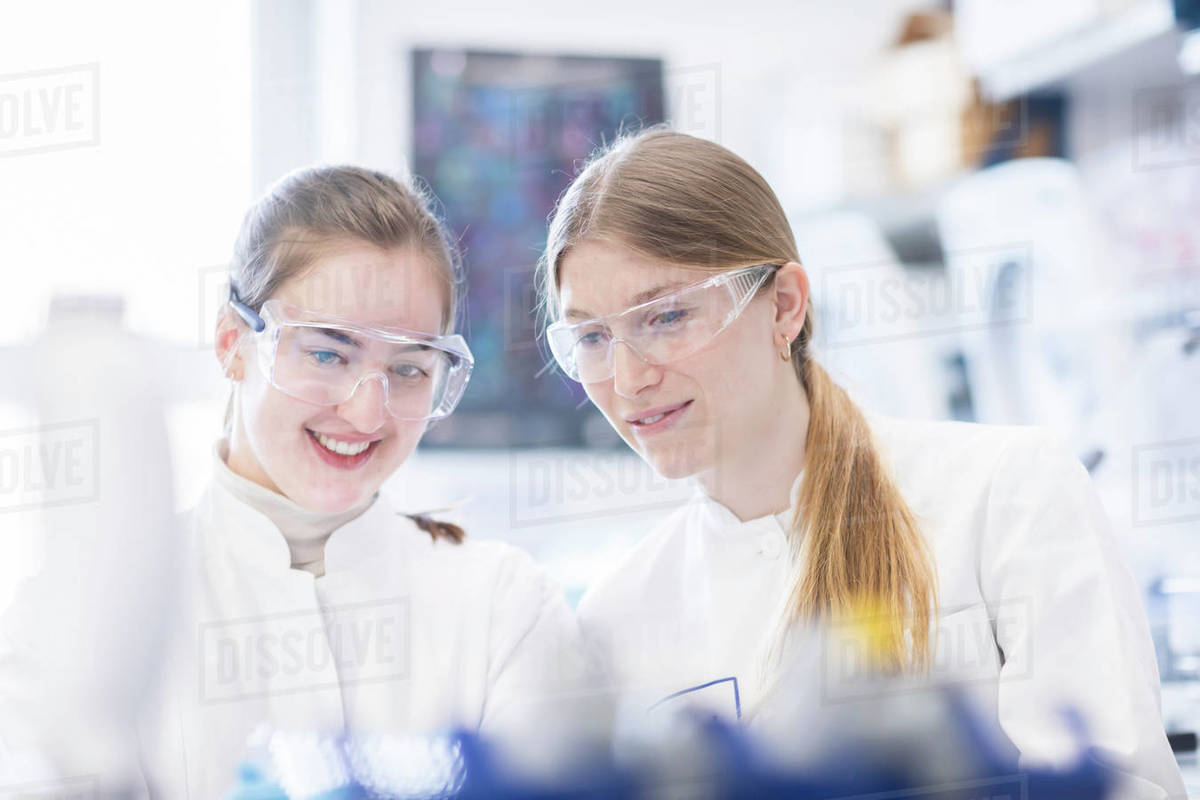 Two scientists engaged in a lively discussion over an experiment in the ...