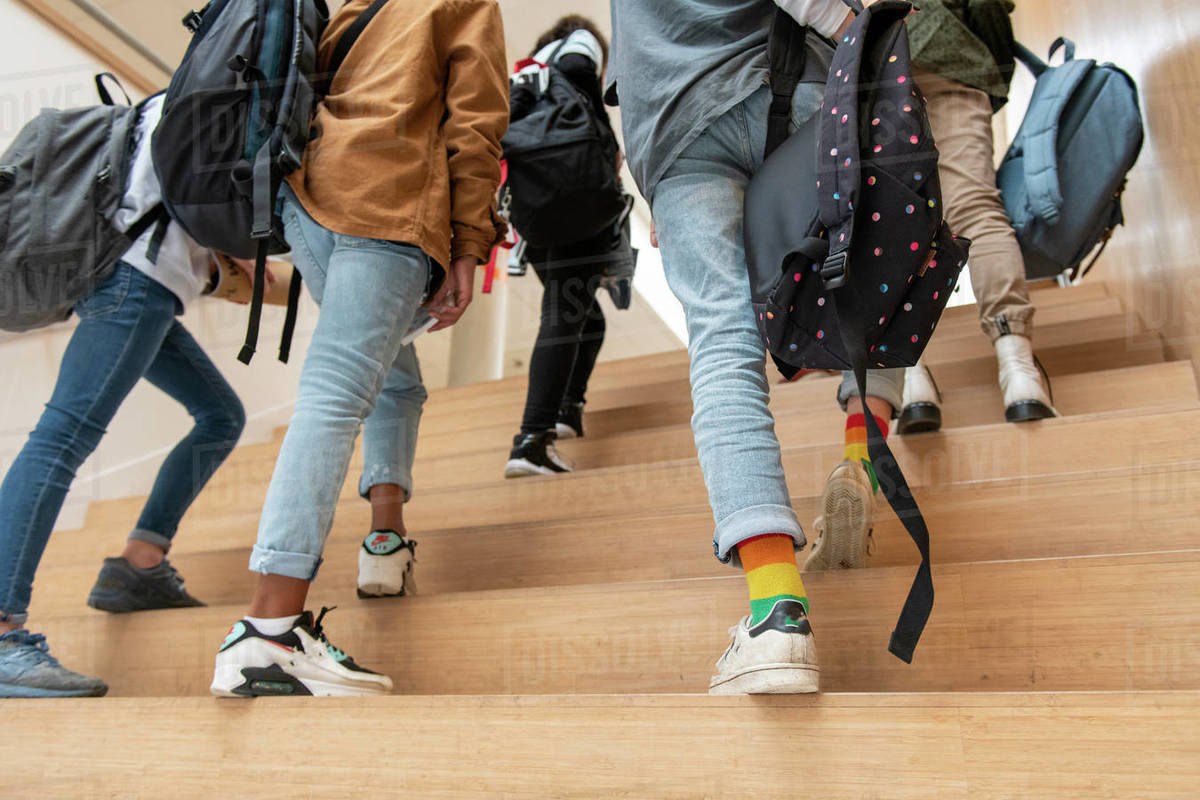 Teenage students walking through the school to their next class - Stock ...