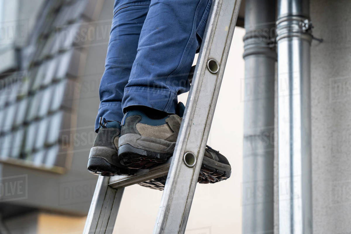 Workers on a ladder performing maintenance work. - Royalty-free Stock ...