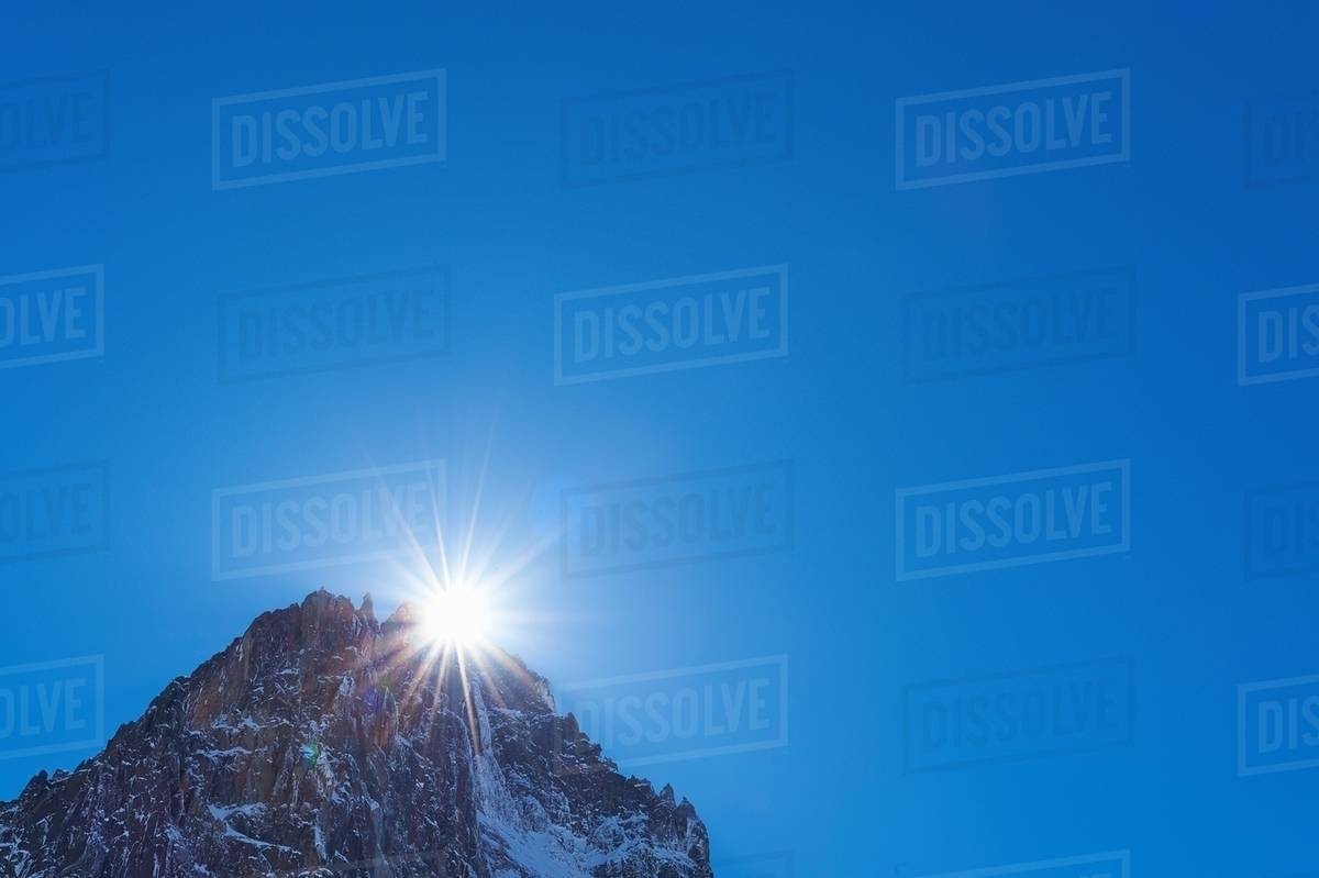 View of rugged mountain peak, sunlight and blue sky, Mont Blanc massif ...