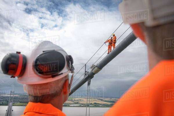Bridge workers working on cable of suspension bridge. The Humber Bridge ...