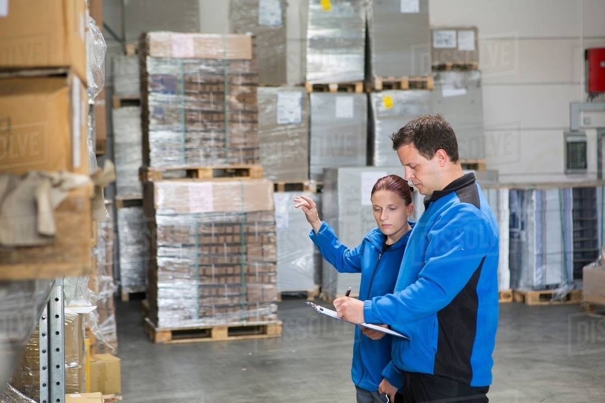 Factory workers checking pallets - Royalty-free Stock Photo | Dissolve