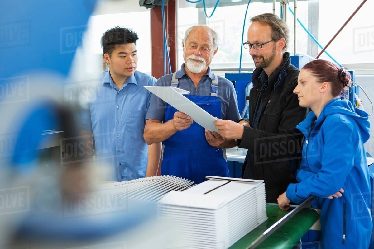 Factory workers with supervisor - Royalty-free Stock Photo | Dissolve