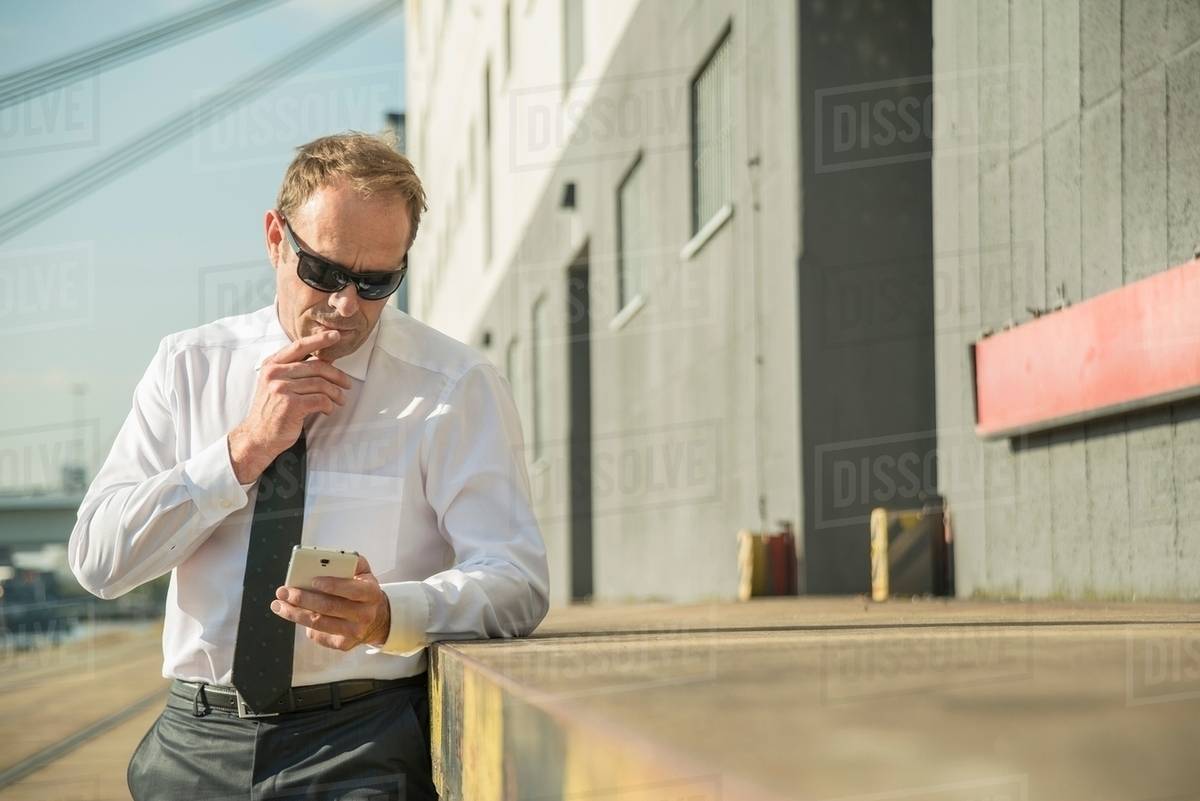 Businessman using smartphone - Royalty-free Stock Photo | Dissolve