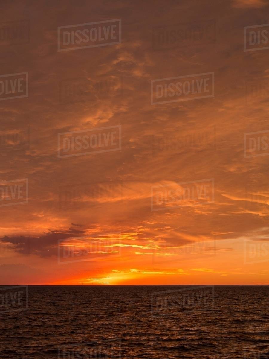 Seascape with sunset over horizon - Royalty-free Stock Photo | Dissolve