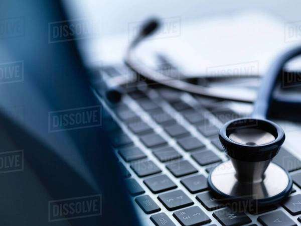 Close up of stethoscope on top of laptop computer keyboard on doctors ...