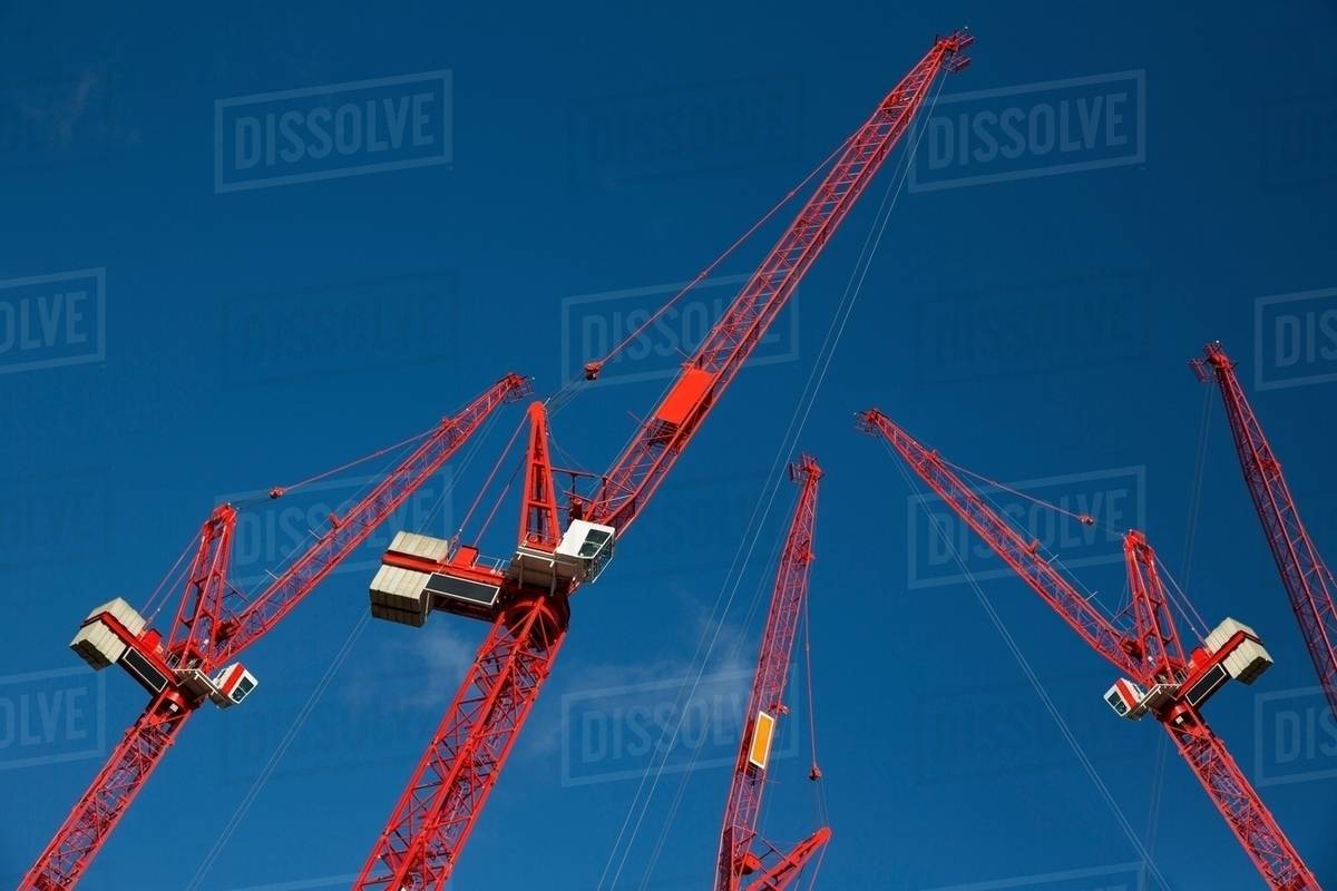 Red construction cranes - Stock Photo - Dissolve