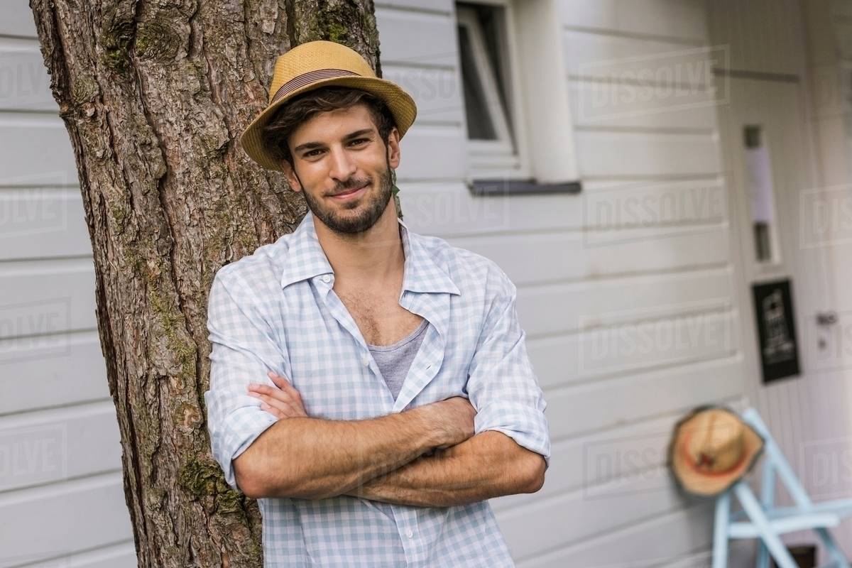 Portrait of young man outside house - Stock Photo - Dissolve