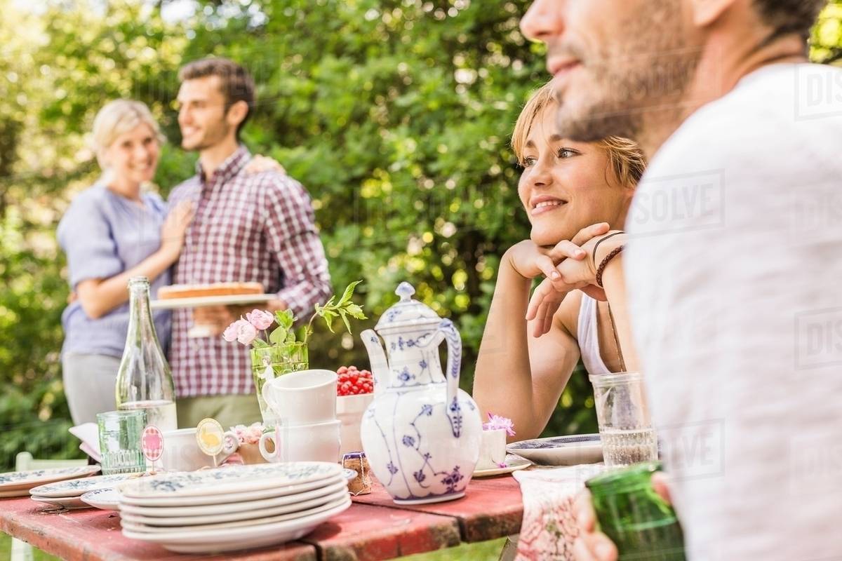 Group of friends at garden party - Stock Photo - Dissolve