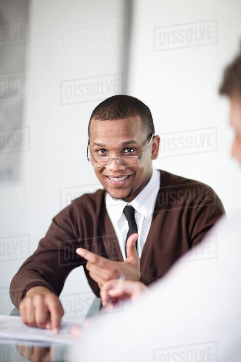 Businessman smiling in meeting - Royalty-free Stock Photo | Dissolve