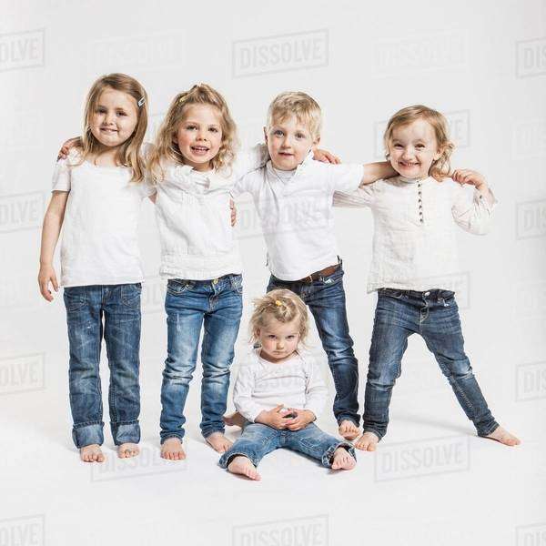Smiling children posing together - Stock Photo - Dissolve