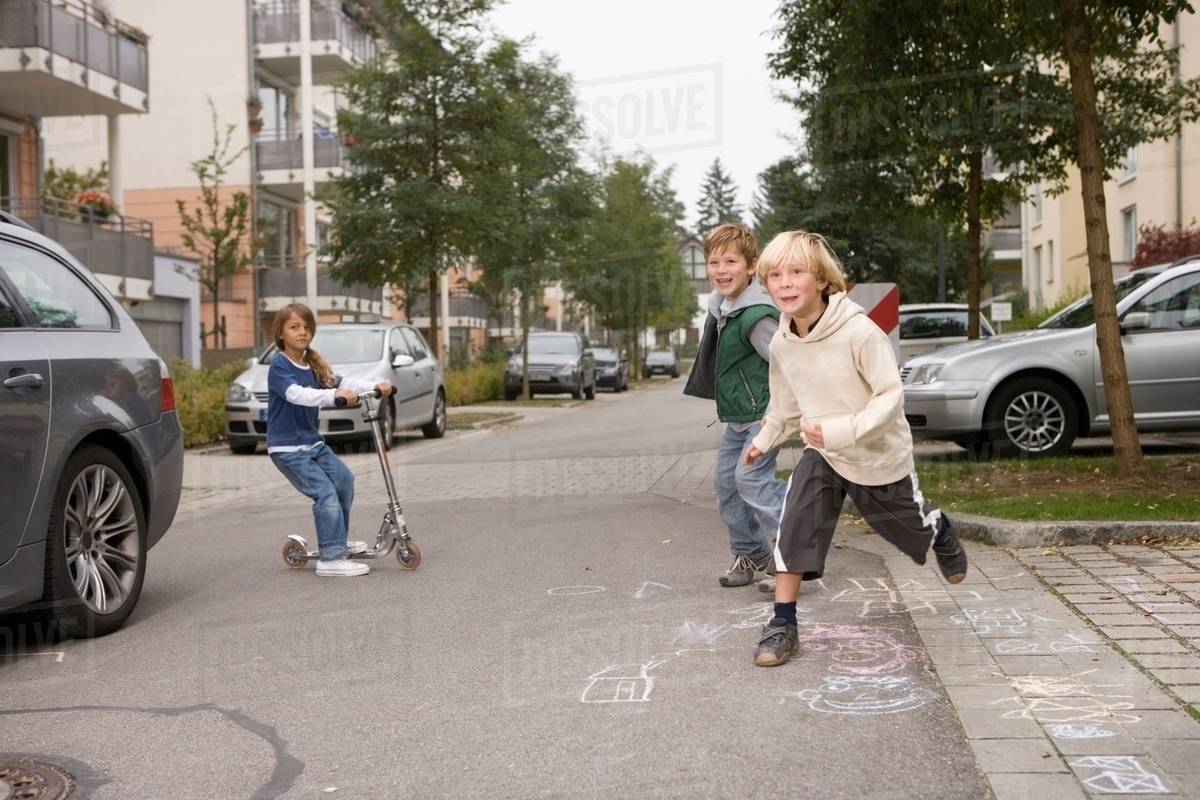 Children playing on suburban street - Royalty-free Stock Photo | Dissolve