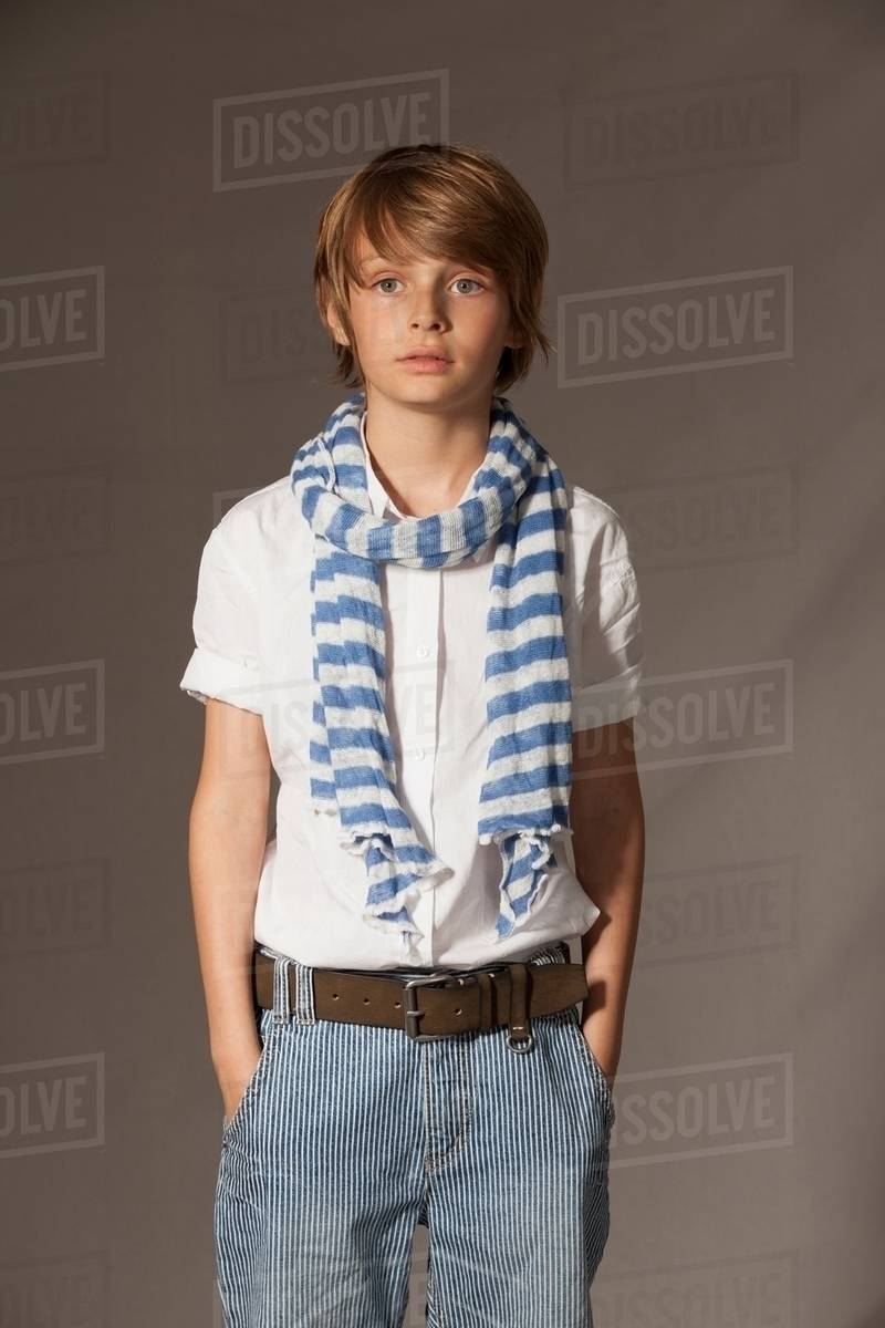 Boy standing in studio - Royalty-free Stock Photo | Dissolve