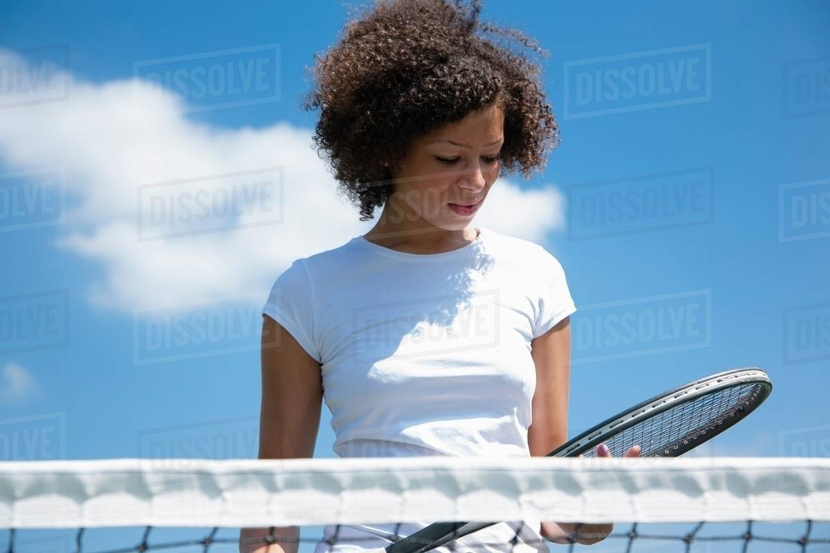Tennis player with racket on court - Royalty-free Stock Photo | Dissolve