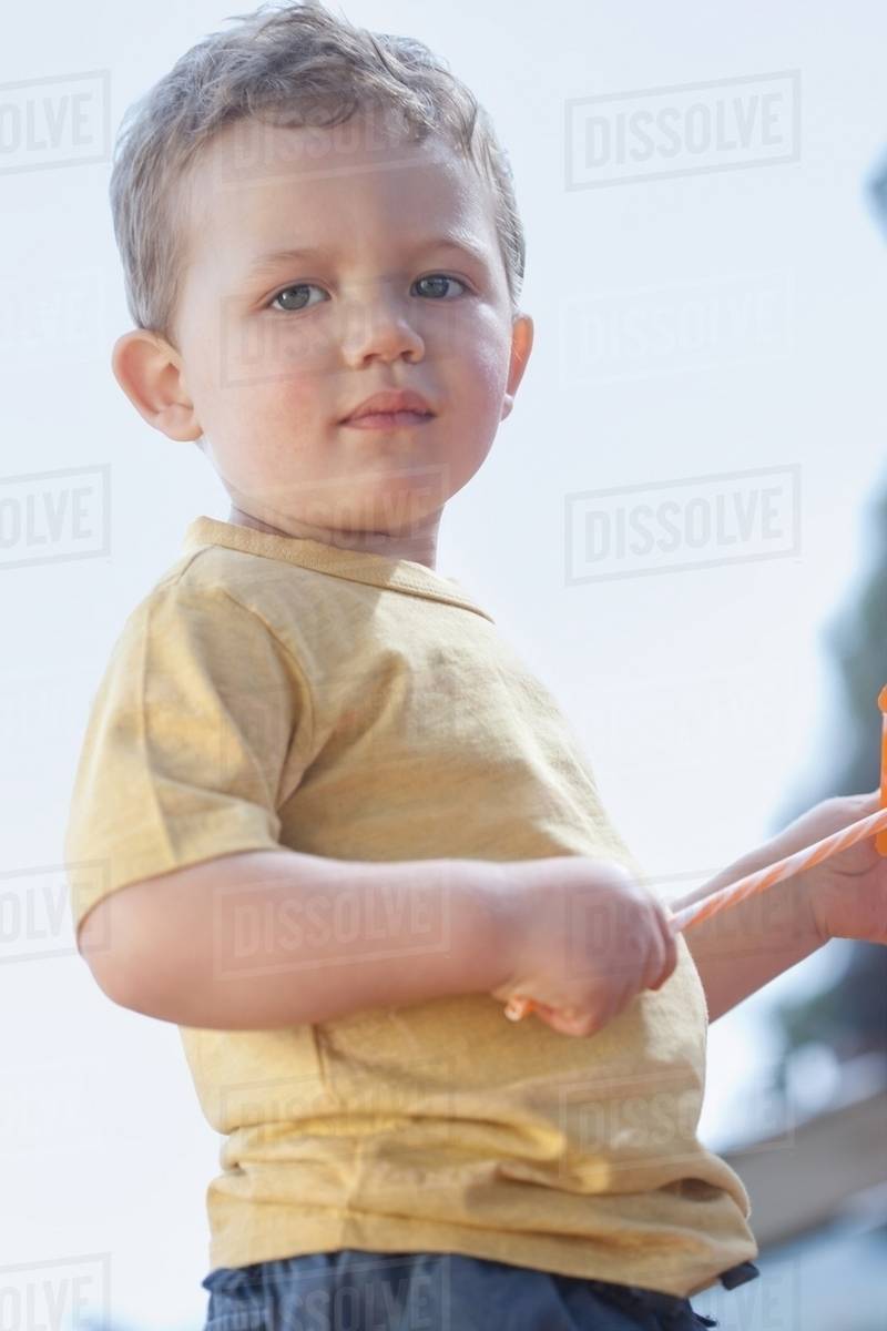 Toddler boy standing outdoors - Royalty-free Stock Photo | Dissolve
