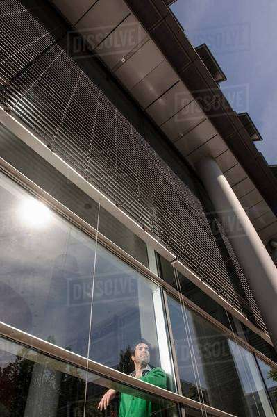 Man standing behind window - Stock Photo - Dissolve