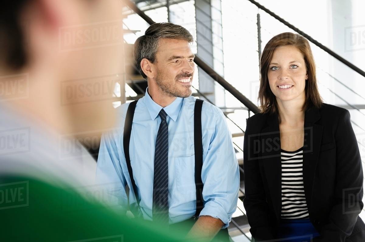 Business people standing in office - Stock Photo - Dissolve