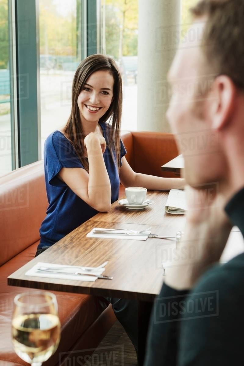 People admiring each other in cafe - Stock Photo - Dissolve