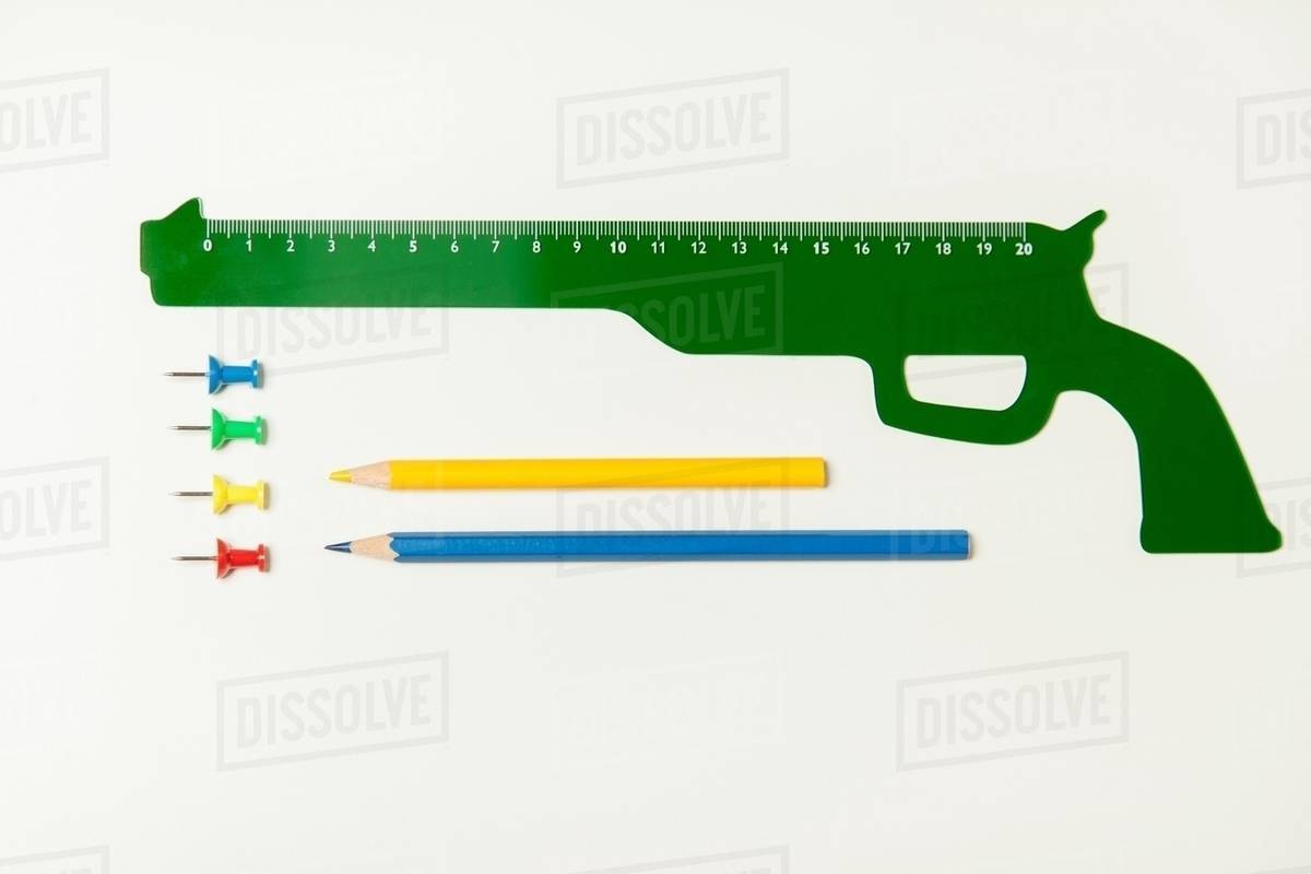 Gun shaped ruler and office supplies - Royalty-free Stock Photo | Dissolve
